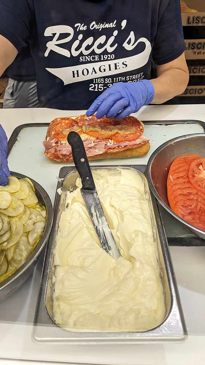 Sandwich assembly as performance art—fresh ingredients waiting their turn to join the carefully choreographed dance of hoagie construction.
