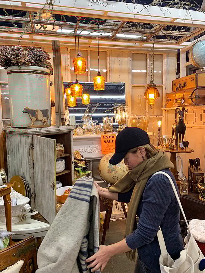 Treasure hunting requires focus and determination. This shopper examines textiles with the concentration of a detective at a crime scene.