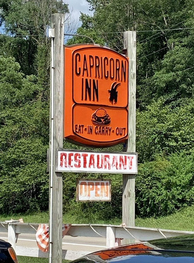 The iconic orange Capricorn Inn sign stands as a beacon of hope for hungry travelers—a roadside promise of honest food done right.