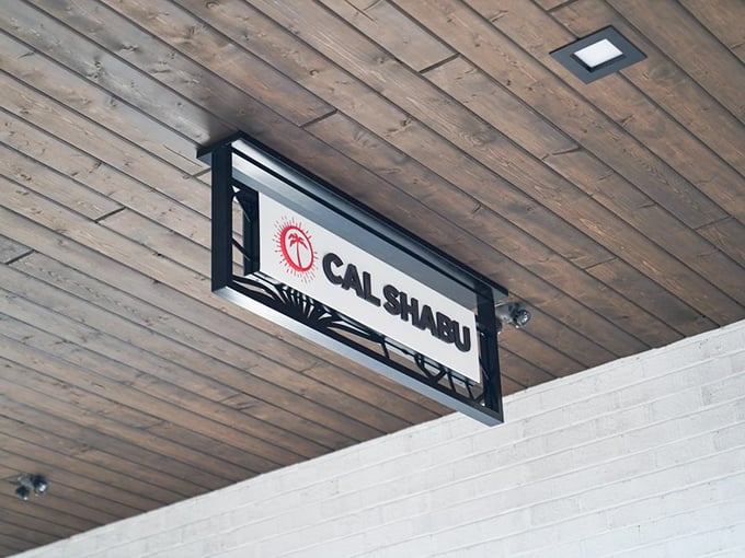 The wooden ceiling sign points the way to culinary adventure, like a North Star for hungry explorers in search of authentic flavors.