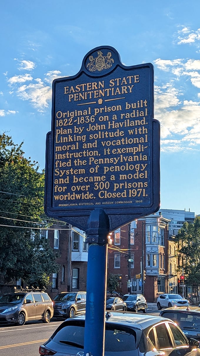 The historical marker tells Eastern State's origin story—a revolutionary concept in 1829 that influenced prison design worldwide for generations to come.