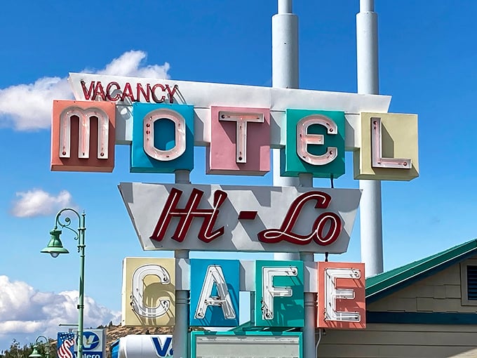 The vintage Hi-Lo sign stands as a colorful beacon for hungry travelers—part roadside Americana, part promise of good things to come.