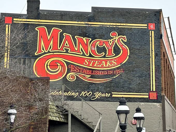 The sign proudly announces "Celebrating 100 Years" – a century of perfecting the art of steak. Some traditions are worth keeping around.