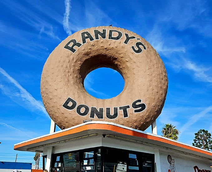 Against the blue California sky, this giant donut isn't just signage—it's a landmark, a photo op, and a promise of deliciousness all in one.
