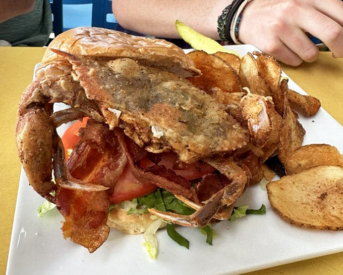 The soft shell crab sandwich—nature's perfect storm of crispy, savory, and sweet, where eating the whole crab is not just allowed but encouraged.