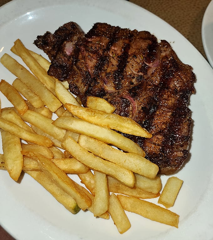 A steak with the perfect sear marks that say "our grill master showed up today." Those golden fries aren't an afterthought – they're essential supporting actors.