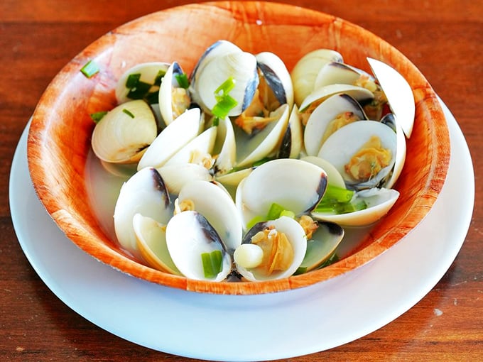 Steamed clams swimming in their own natural juices—oceanic simplicity that proves sometimes the best cooking means knowing when to stop.