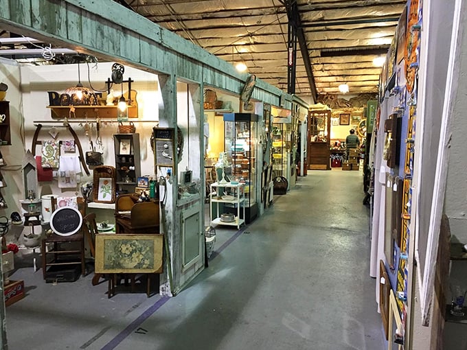 The vendor stalls create charming storefronts within the larger space – like a Main Street from the past preserved indoors.