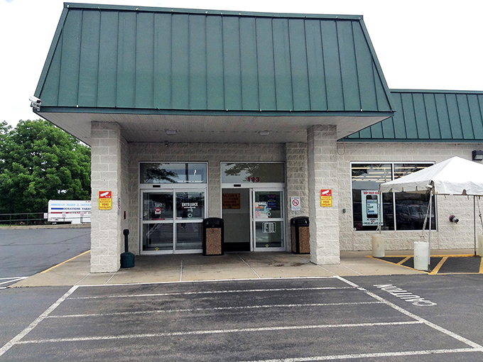 The unassuming entrance to bargain paradise – where the real magic happens behind those modest doors and under the green-trimmed roof.