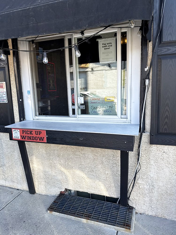 The take-out window—where dreams come true for those who want their cheesesteak fix without leaving the car. Convenience never tasted so good.