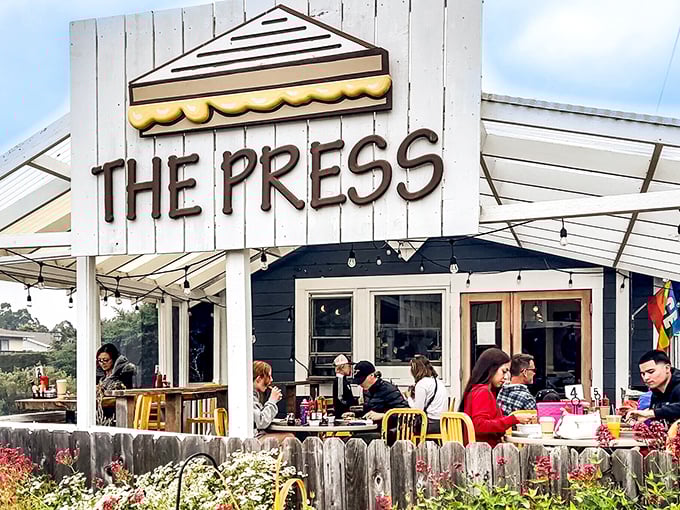 The Press isn't just serving coffee; it's hosting the daily gathering of locals who know that caffeine tastes better with coastal air.
