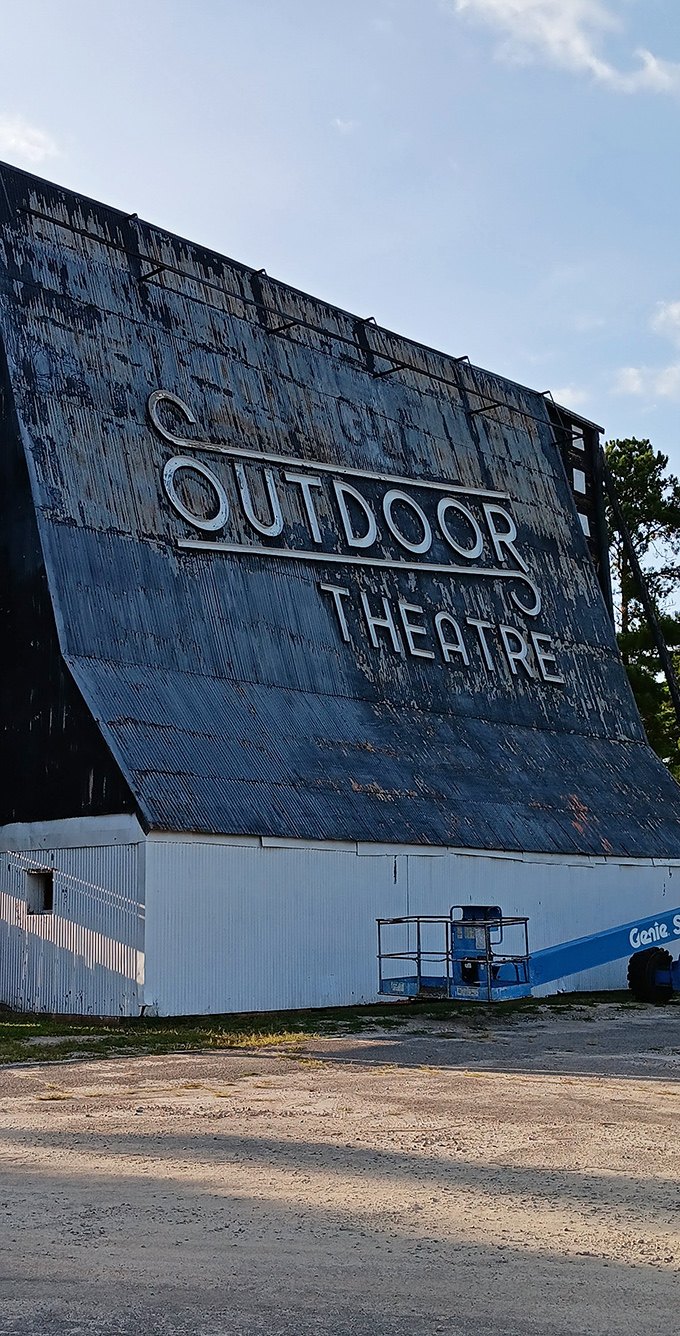 The weathered patina of this massive screen tells stories of its own—of summer storms weathered and thousands of films projected.