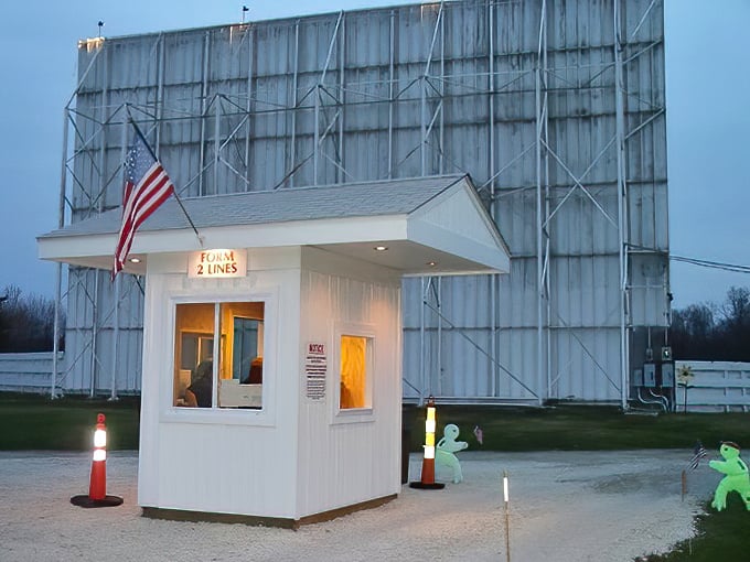 The ticket booth glows like a tiny lighthouse, your gateway to an evening of outdoor entertainment.