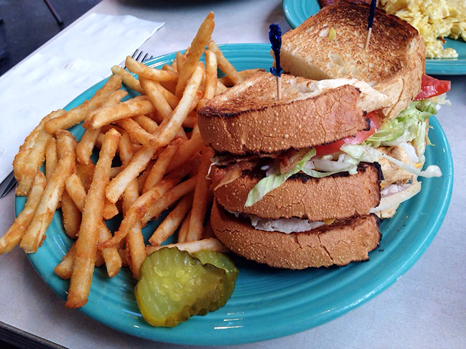 A sandwich stacked higher than Pittsburgh's parking tickets. The pickle isn't just garnish—it's essential acid balance for this towering creation.