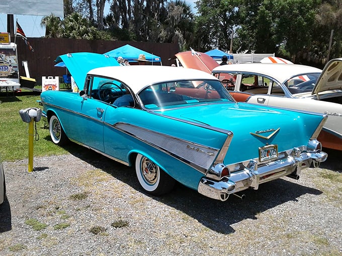 This turquoise 1957 Chevy Bel Air isn't just parked at the drive-in—it's completing a perfect time-travel experience. Chrome gleaming in Florida sunshine.