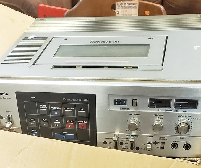 The Panasonic VHS player – a technological time capsule from when "Be Kind, Rewind" wasn't just good advice, it was store policy.