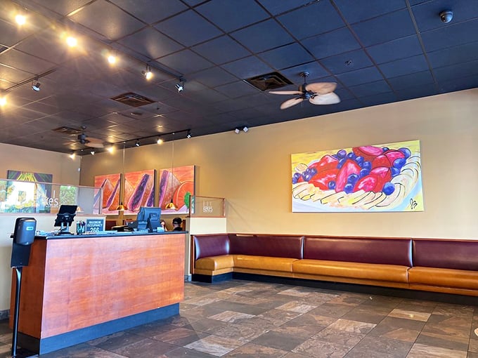 The waiting area where breakfast anticipation builds. Those colorful food paintings aren't helping anyone's patience, but they're worth the wait.