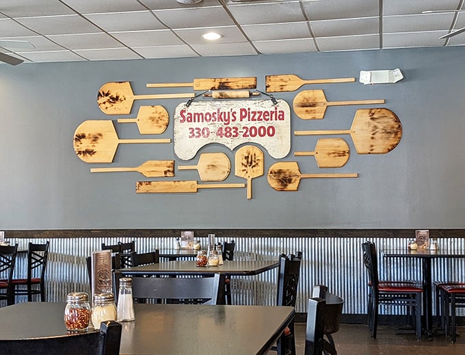 Pizza paddles transformed into wall art—a creative reminder that you're in the hands of people who take their pizza craft seriously.