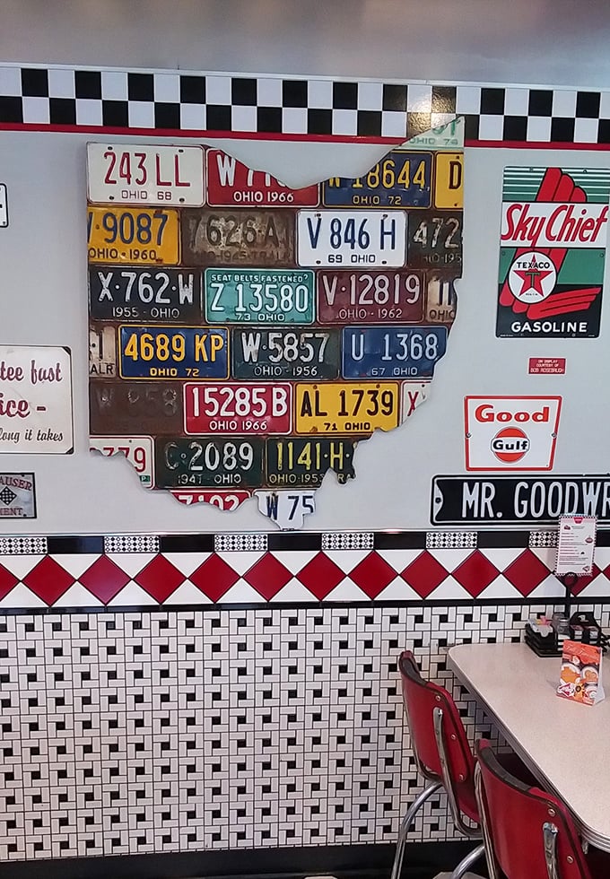 Ohio pride displayed through vintage license plates arranged in state formation. Nostalgia isn't just served on plates—it covers the walls too.