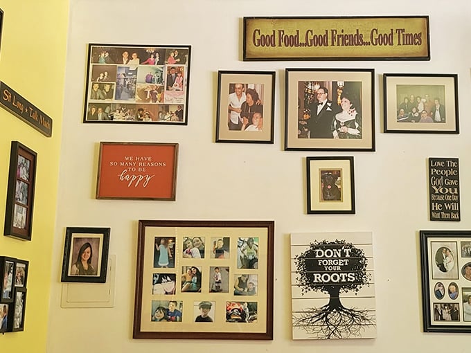 Family photos and inspirational quotes create a living scrapbook on sunny yellow walls. "Good Food...Good Friends...Good Times" isn't just decor—it's a promise.