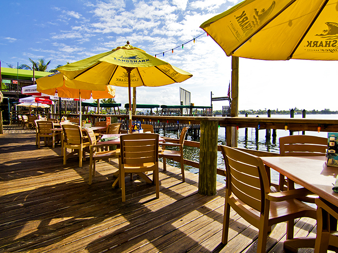 Yellow umbrellas dot the deck like sunshine puddles. The waterfront seating offers prime real estate for both eating and boat-watching.