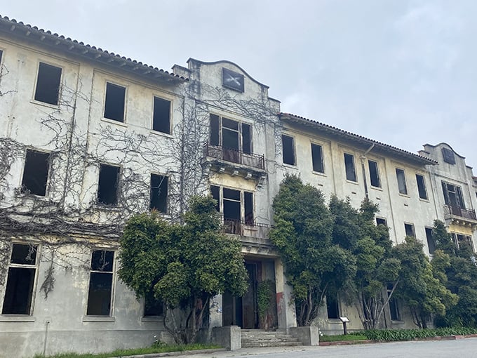 The abandoned military hospital stands hauntingly beautiful, its empty windows framing views that once comforted recovering soldiers decades ago.