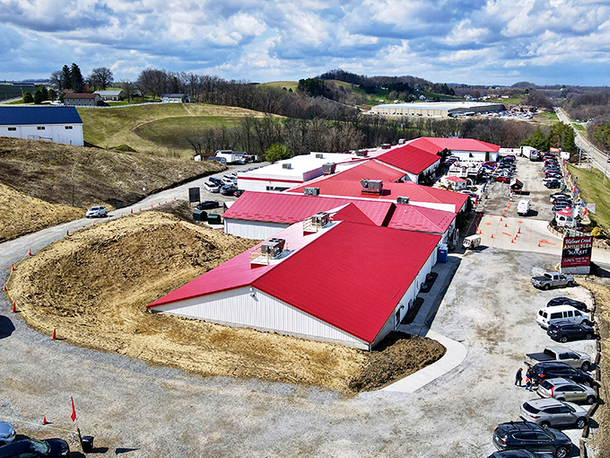 The marketplace from above—a red-roofed wonderland nestled in rolling countryside that makes even non-shoppers want to explore.