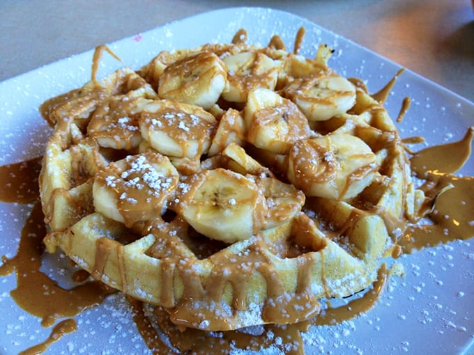 This isn't just a waffle with bananas—it's architecture with purpose, a foundation for maple syrup rivers and butter pools of extraordinary depth.