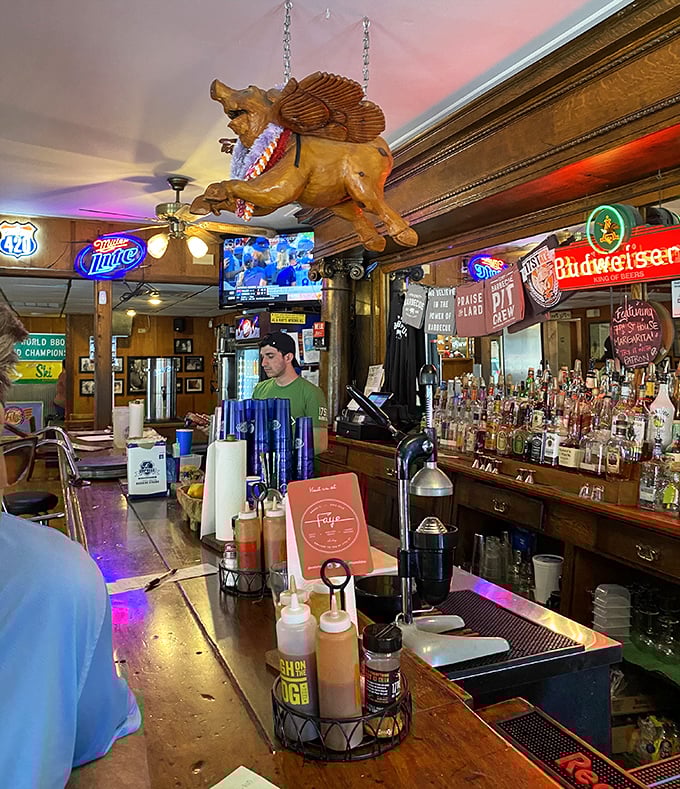 The flying pig chandelier watches over patrons like a whimsical guardian angel of pork, a reminder not to take food too seriously.