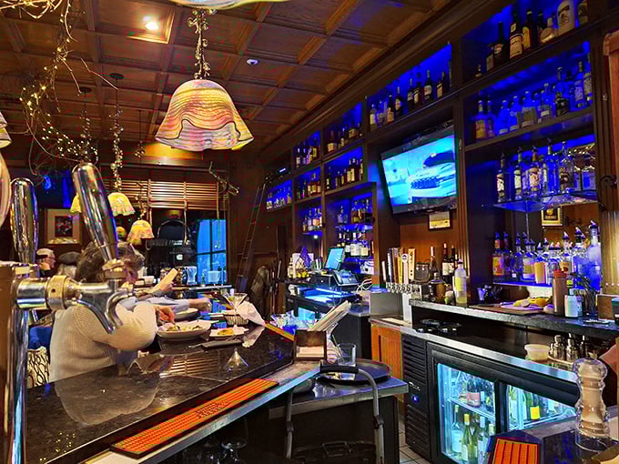 A bar that takes its liquid artistry seriously. That blue backlit display isn't just pretty—it's showcasing an impressive arsenal of spirits ready for action.