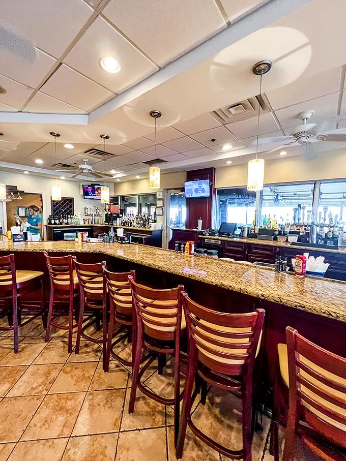 The bar at Shuckers—where locals and visitors alike find common ground over cold drinks and the promise of fresh seafood.