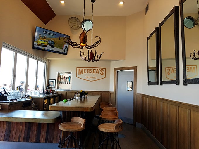The bar area whispers "maritime charm" without shouting "tacky nautical theme park"—just the right balance of wood, warmth, and octopus lighting.