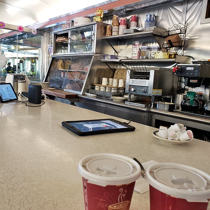 The counter where magic happens—stainless steel, perfectly arranged mugs, and the promise of coffee that never runs dry.