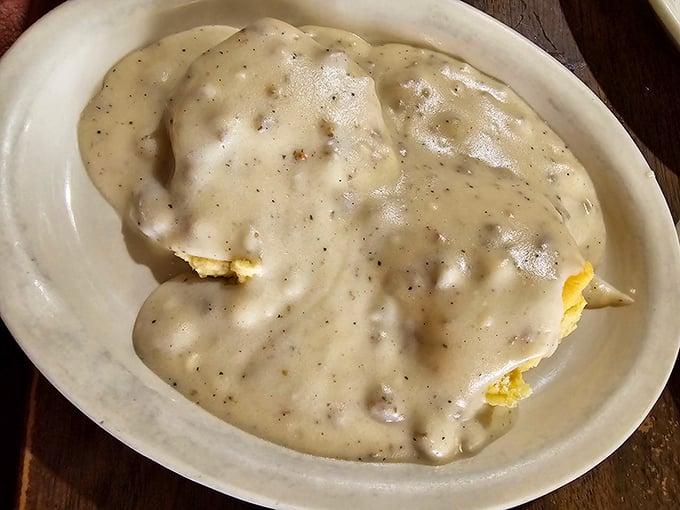 Biscuits completely surrendering to gravy—a breakfast dish so comforting it should come with a warning label about inducing food-related happiness.