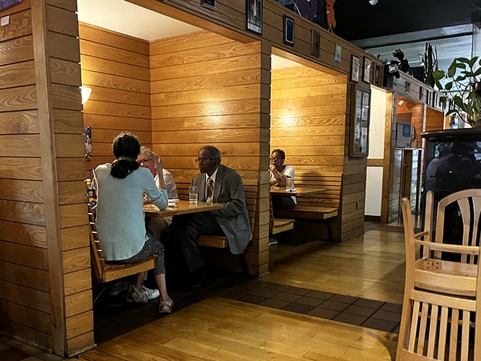 These wooden booths offer the perfect balance of privacy and community—cozy enough for intimate conversations, yet part of something bigger.