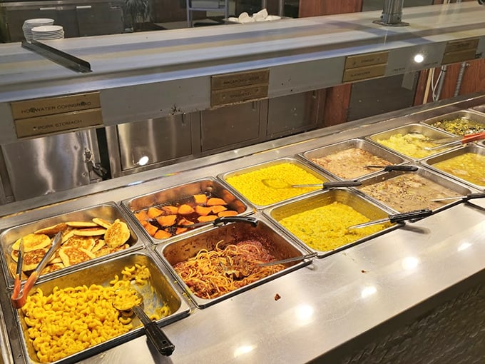 The buffet line stretches with golden mac and cheese, sweet corn, and pasta dishes—a parade of comfort foods waiting for your plate.