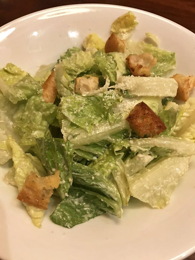 A Caesar salad that actually tries—crisp romaine, proper dressing, and croutons that weren't born in a factory three months ago.