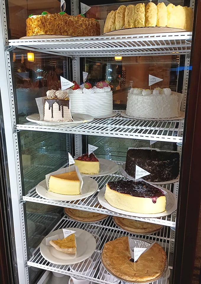 The dessert case – where willpower goes to die a glorious death. Each cake and pie patiently waiting its turn to become the highlight of someone's day.