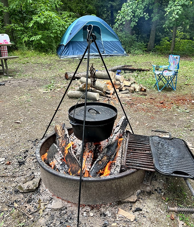 Campfire cooking doesn't get more authentic than this—a cast iron pot suspended over flames, promising meals that taste like adventure.