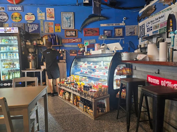 The market side reveals a nautical-themed wonderland where fish replicas watch over the day's fresh catch with approving glass eyes.