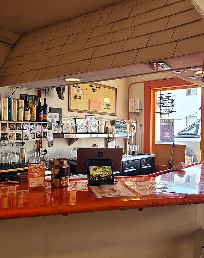 That gleaming orange counter isn't just functional—it's the stage where burger magic happens, complete with all the supporting characters.
