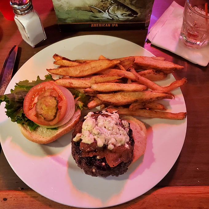 A burger that requires a strategic approach – compress or unhinge your jaw? Either way, those hand-cut fries are the perfect supporting cast.