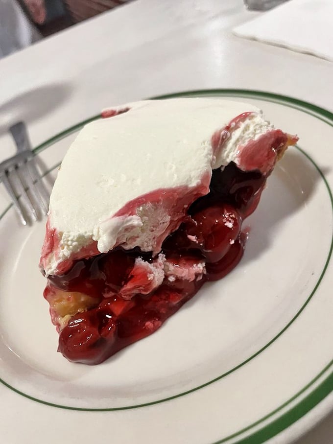 Cherry pie topped with whipped cream—tart meets sweet in a relationship that works better than most rom-coms. That crimson filling is pure drama.