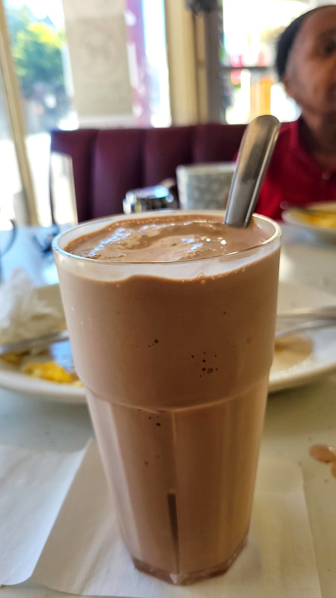 This chocolate shake isn't just a beverage – it's a time machine back to when diners ruled and straws were built to handle serious milkshake business.