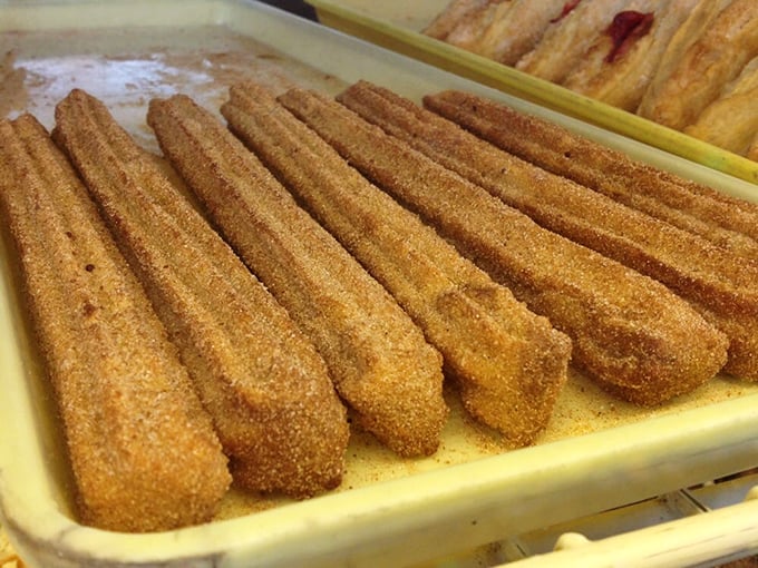 Cinnamon-sugar churros lined up like delicious soldiers, ready to march straight into your heart (and possibly your arteries).
