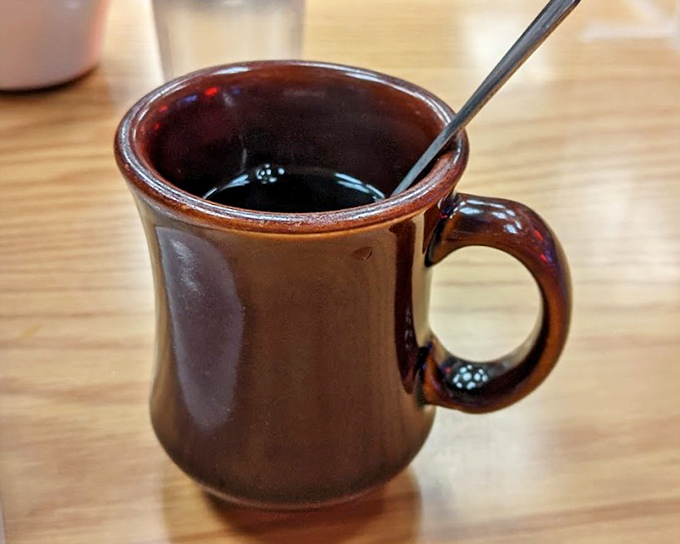 That brown ceramic mug isn't just holding coffee—it's holding the fuel that powers Portland, one satisfying sip at a time.