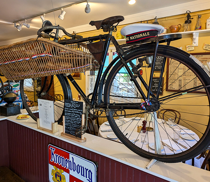 This vintage French bicycle isn't just decoration – it's a time machine to the streets of Paris, perfectly at home among the restaurant's authentic bistro atmosphere.