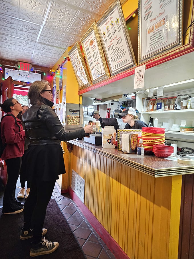 The ordering counter—where hot dog dreams come true. Those gold-framed menus aren't just decorative; they're treasure maps to flavor country.