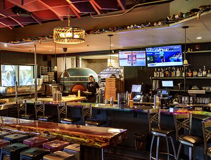 The bar area reveals the true star – that magnificent tiled oven visible from every seat, promising smoky delights to come.