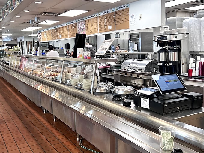 Behind this counter, deli magic happens daily—meats sliced to order, salads scooped with generous hands, and sandwiches assembled with architectural precision.